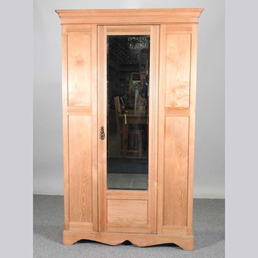 Lot 108 - An Edwardian light ash single wardrobe, with